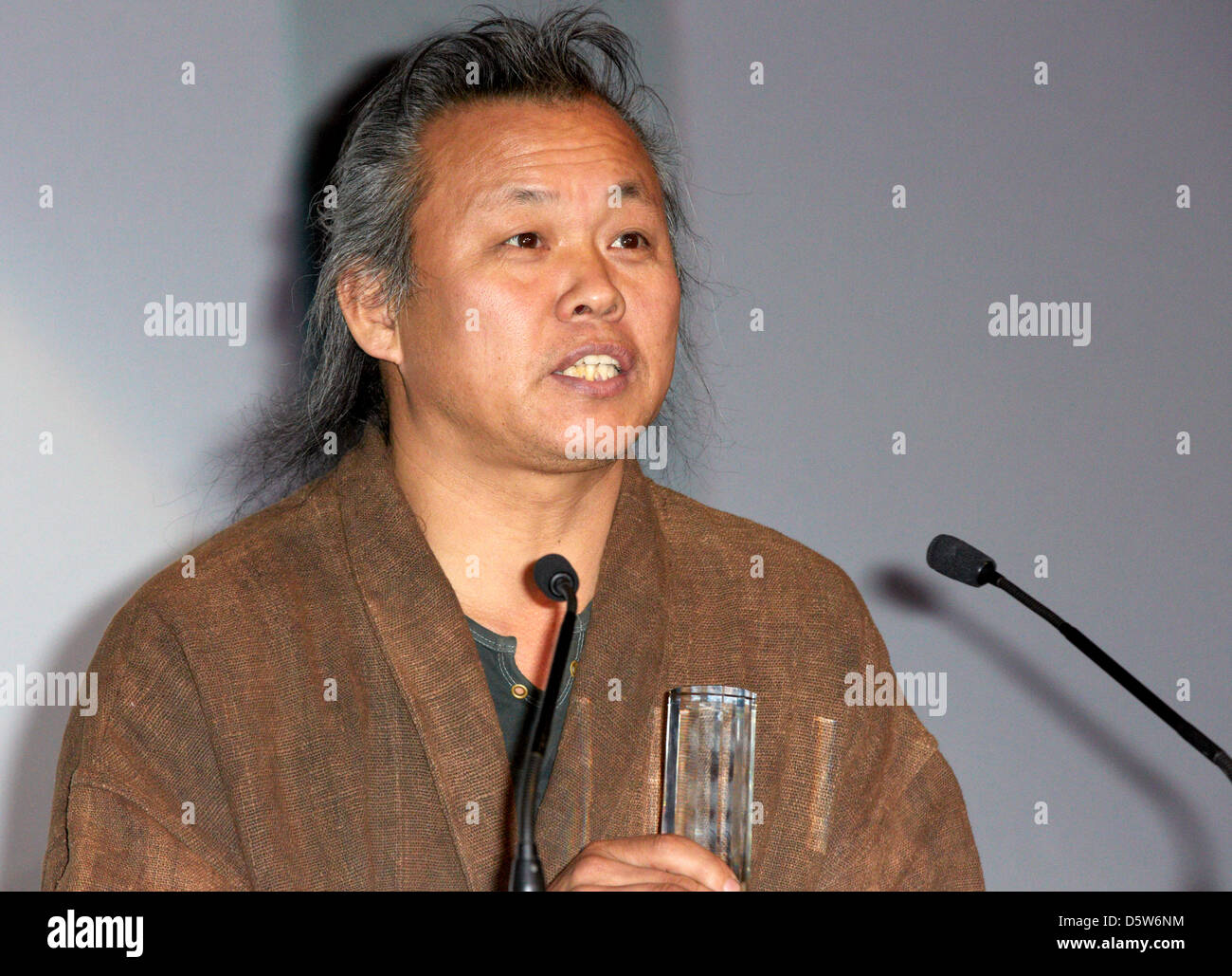 South Korean director Kim Ki-duk delivers a speech after he received ...