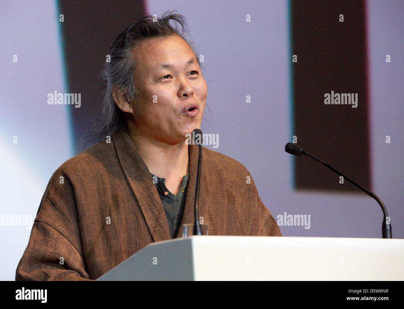 South Korean director Kim Ki-duk sings a song after he received the ...