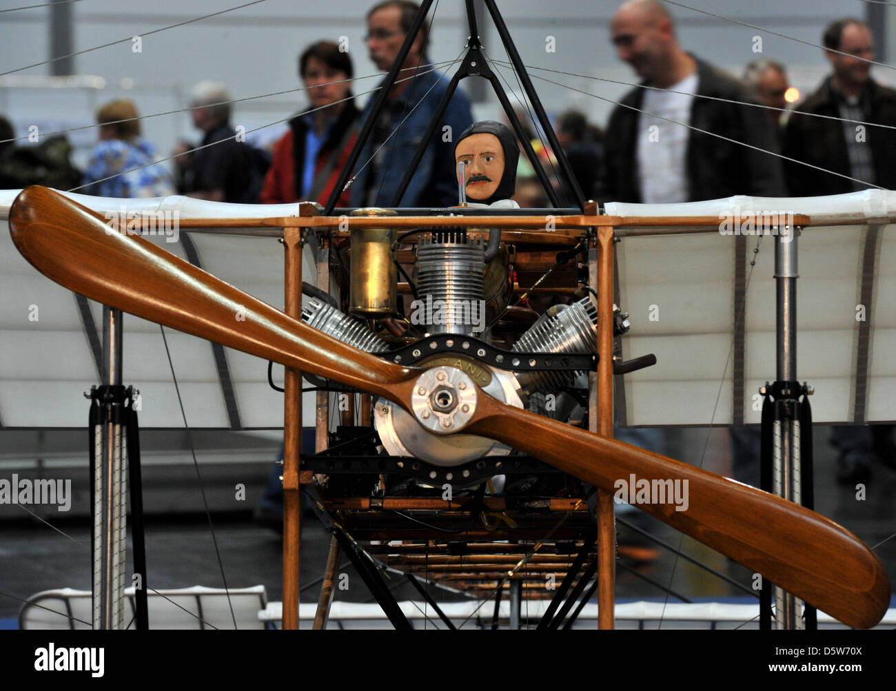 Visitors walk behind a model of a Beleriot IX plane at the modell-hobby ...