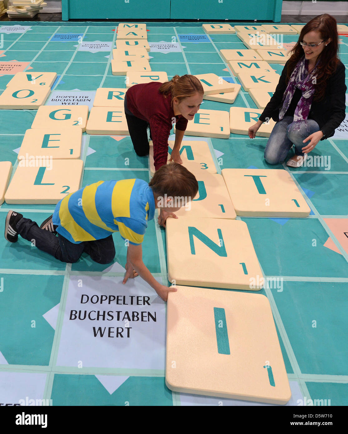 Visitors play a large-scale version of "Scrabble" at the modell-hobby ...