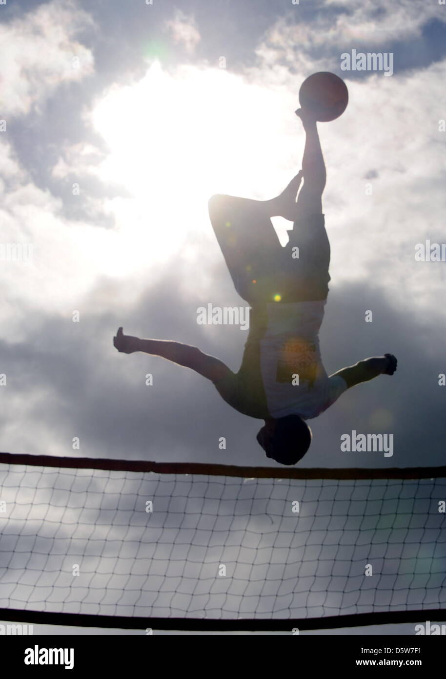 A man demonstrates the new trend sport Bossaball at the beach of the ...