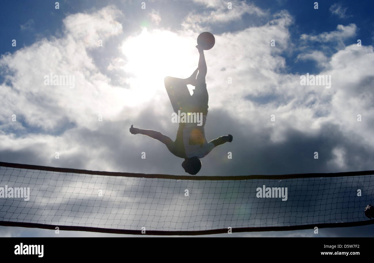 A man demonstrates the new trend sport Bossaball at the beach of the ...