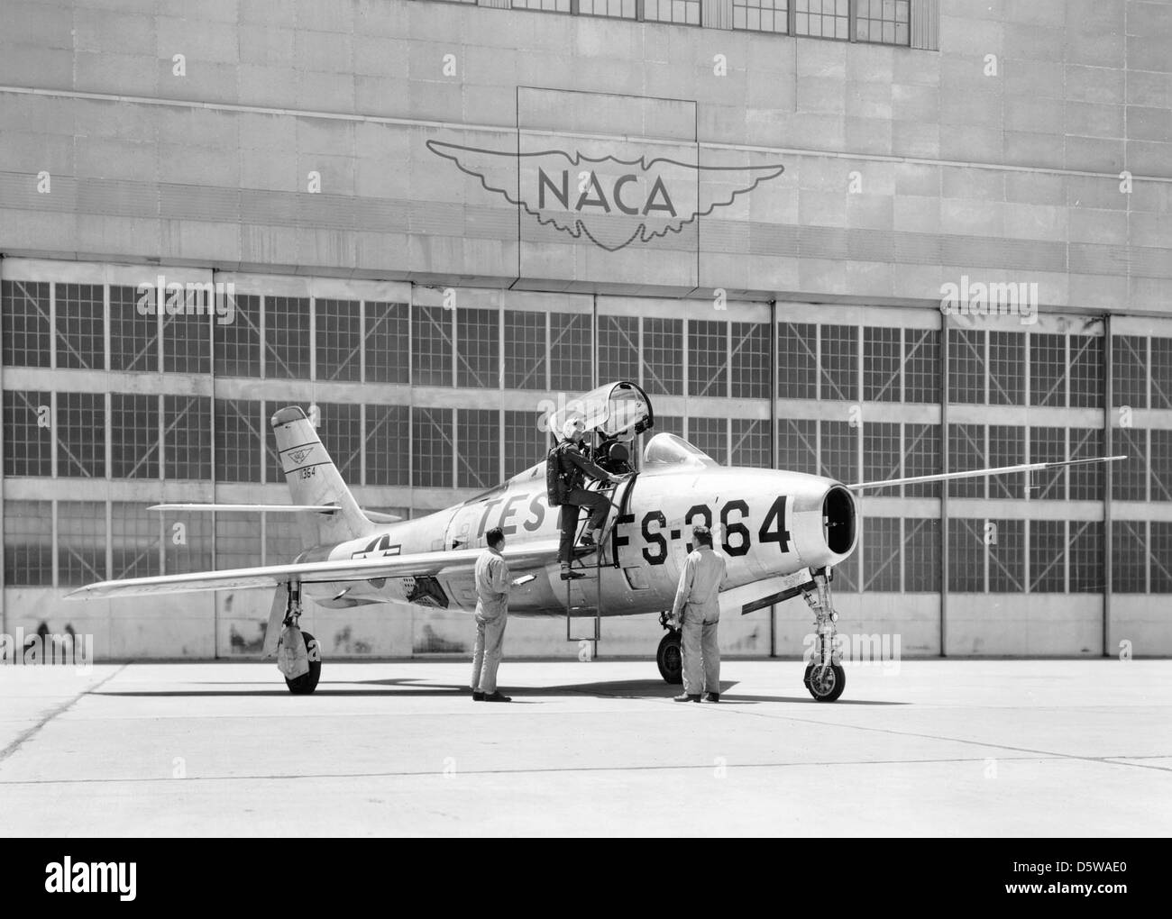 NASA test pilot George E. Cooper is pictured with a Republic F-84F ...