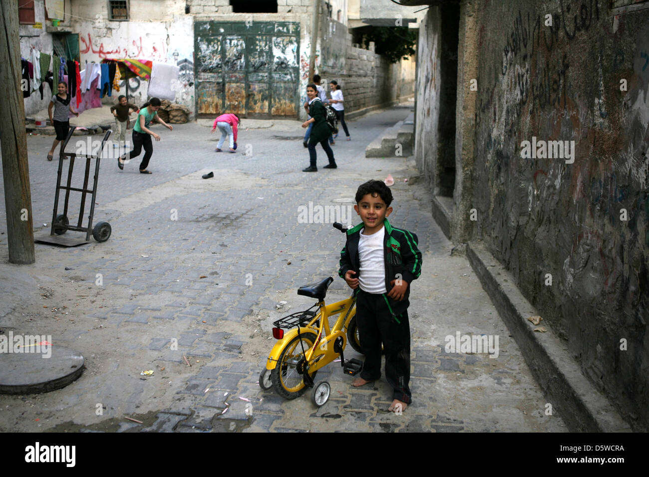Rafah, Gaza Strip. April 9, 2013. Palestinian children play outside ...