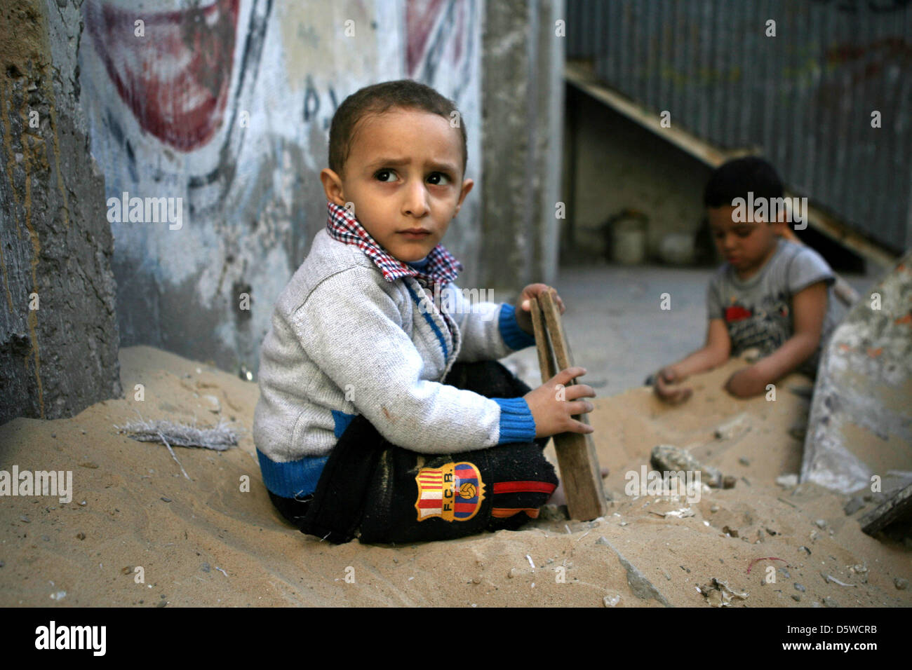 Rafah, Gaza Strip. April 9, 2013. Palestinian children play outside ...