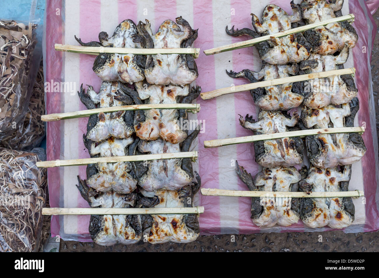 Freshly grilled toads on a asian market Stock Photo - Alamy