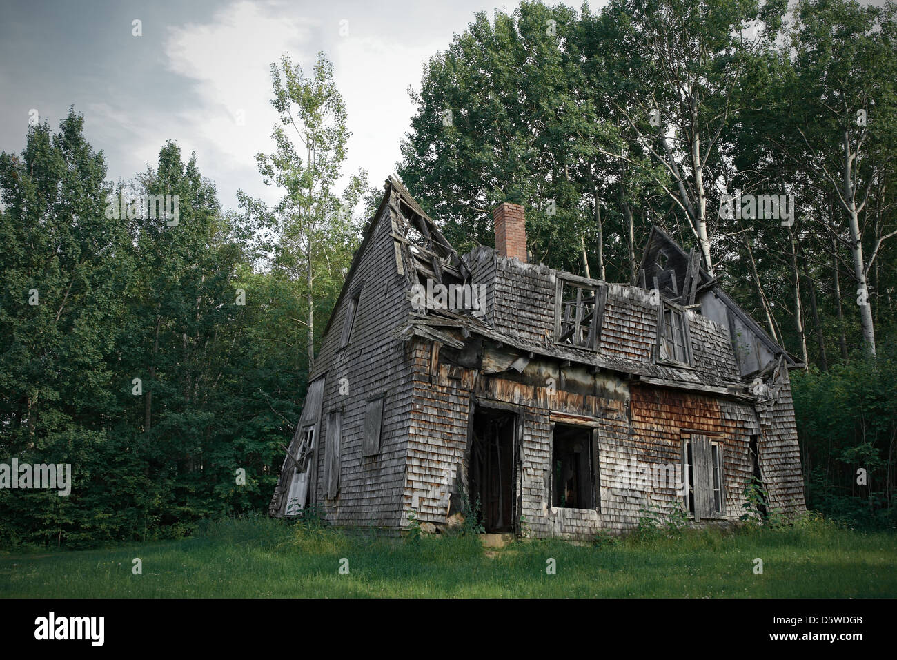 Spooky haunted house among the trees Stock Photo - Alamy