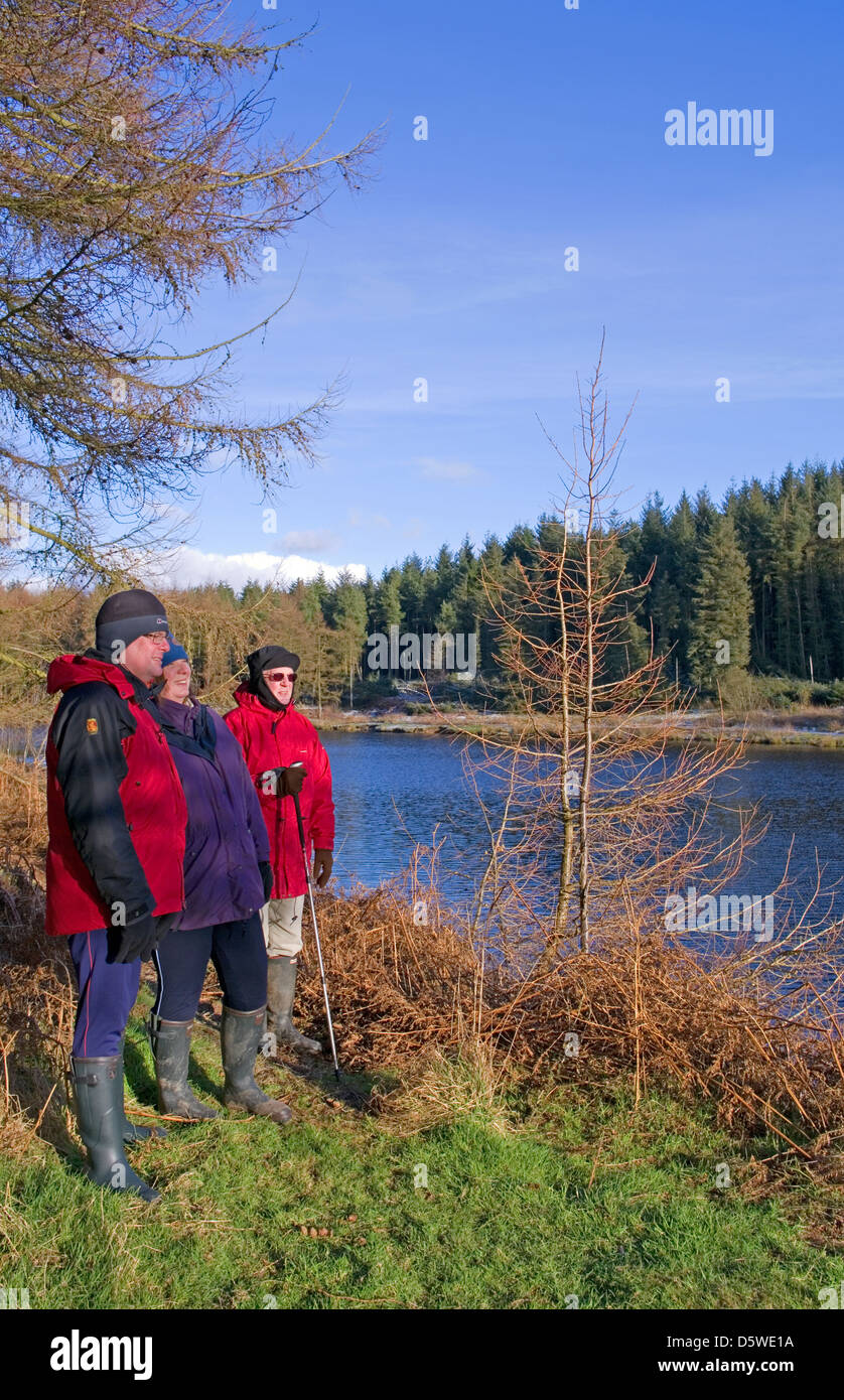 Three walkers at Cod Beck Reservoir near Osmotherley, North York Moors ...