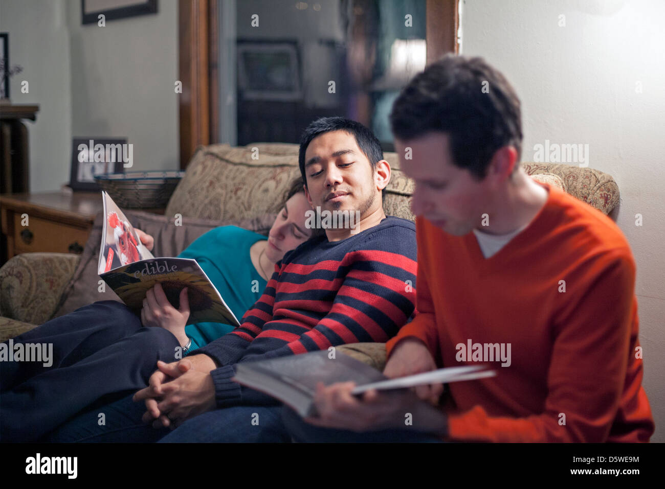 Three family members share some quiet time reading before going to ...