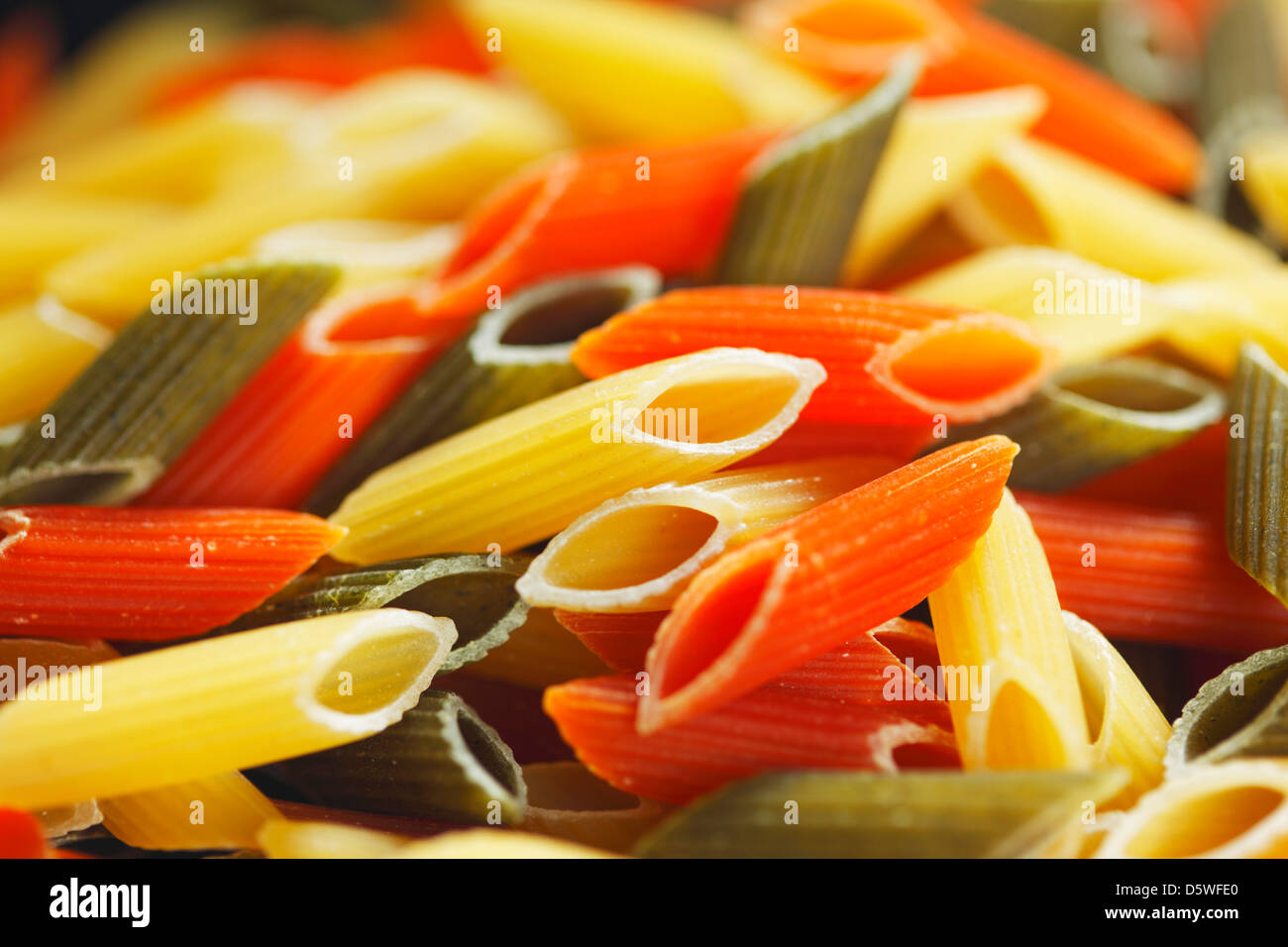 Colored dry italian pasta background Stock Photo - Alamy