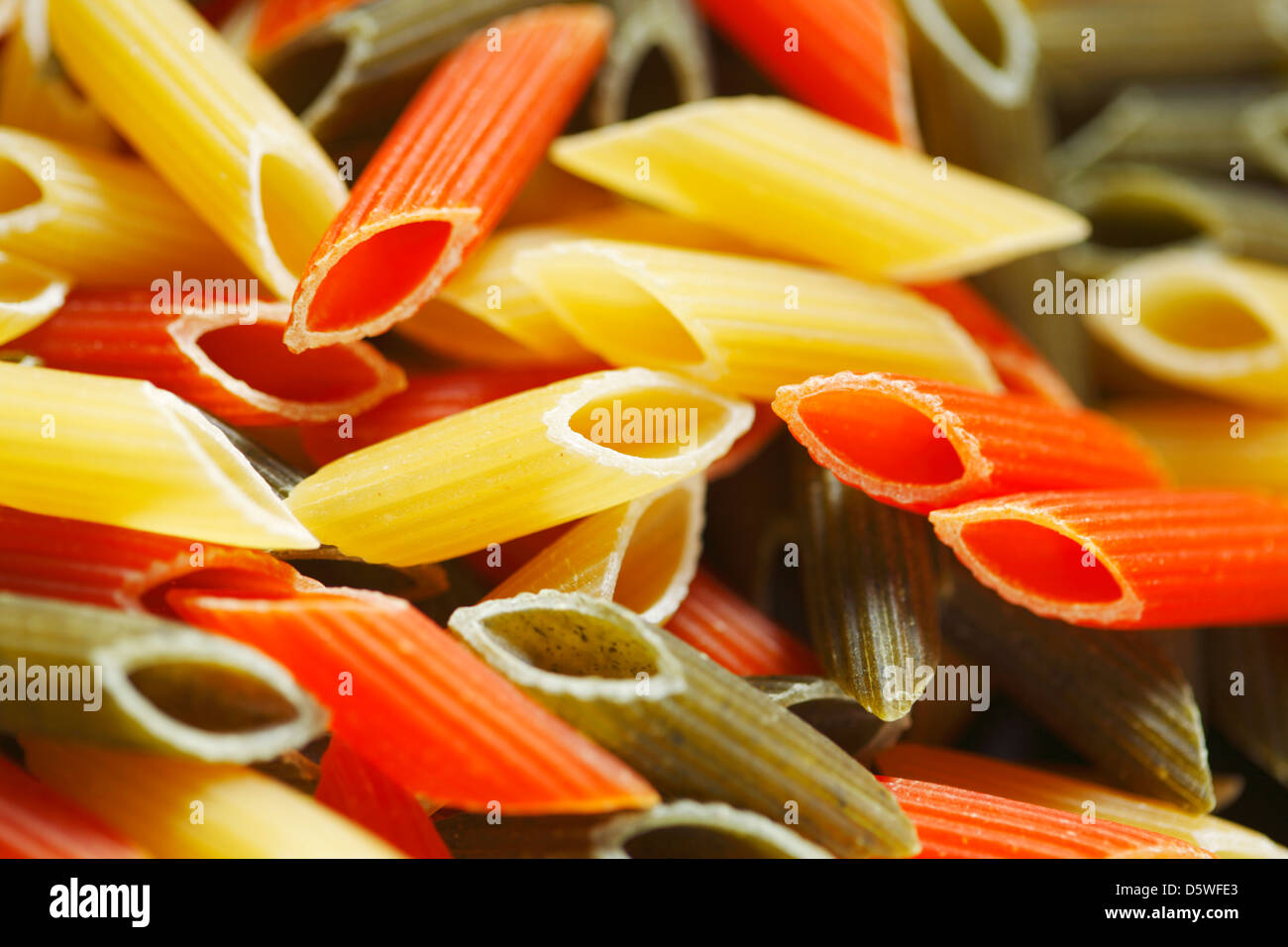 Colored dry italian pasta background Stock Photo - Alamy