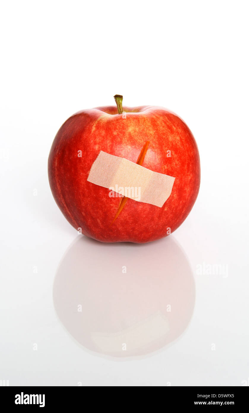 Injured red apple with a plaster Stock Photo - Alamy