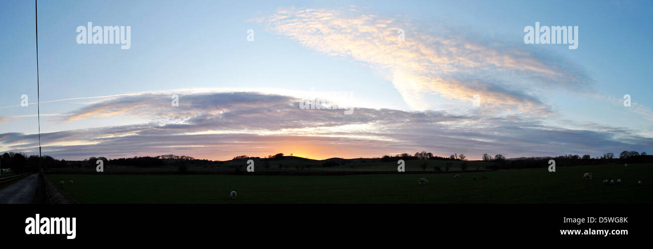 A photograph of a sunset over a field Stock Photo - Alamy