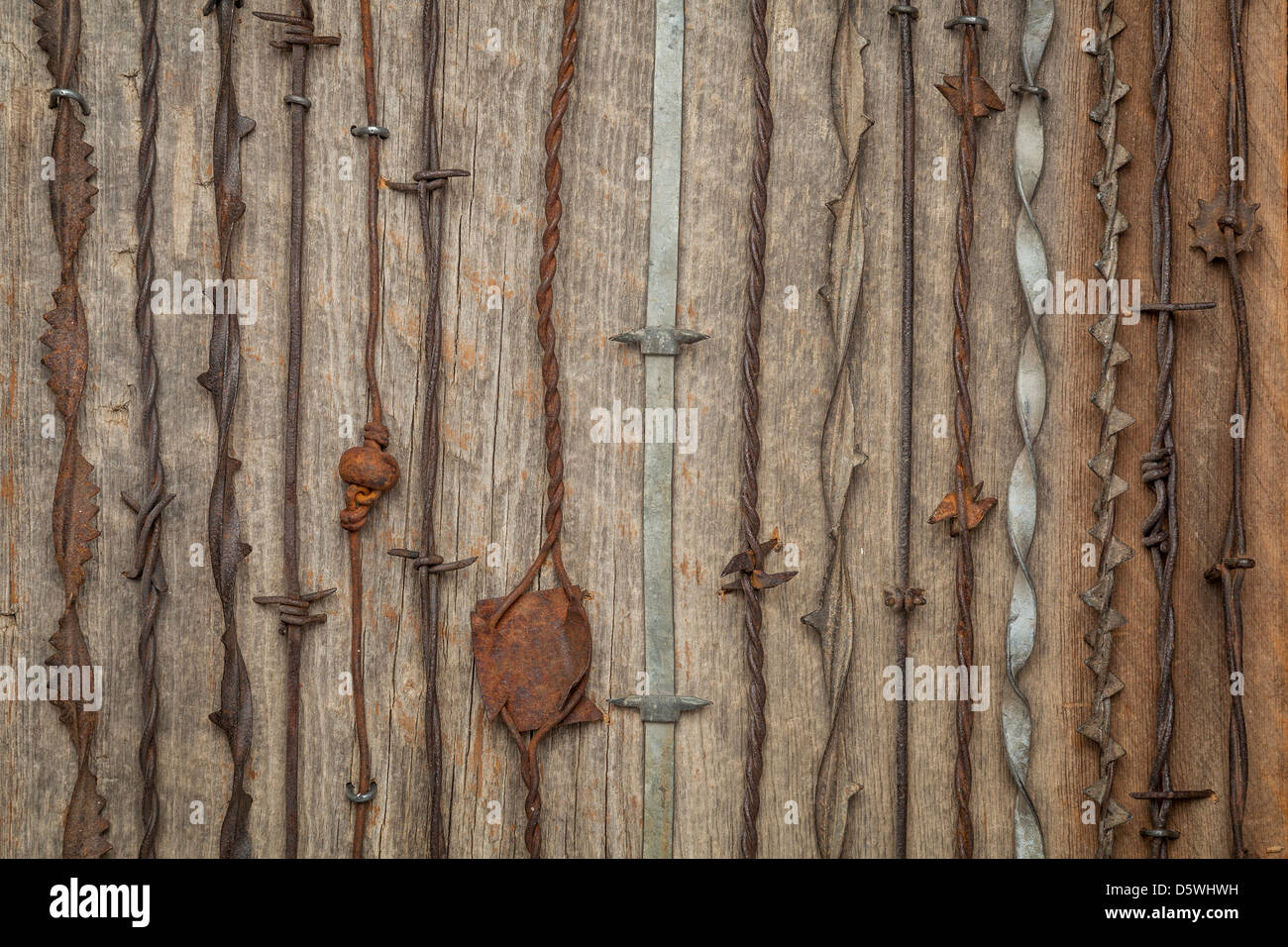 vintage rusty barbed wire collection against barn wood Stock Photo - Alamy