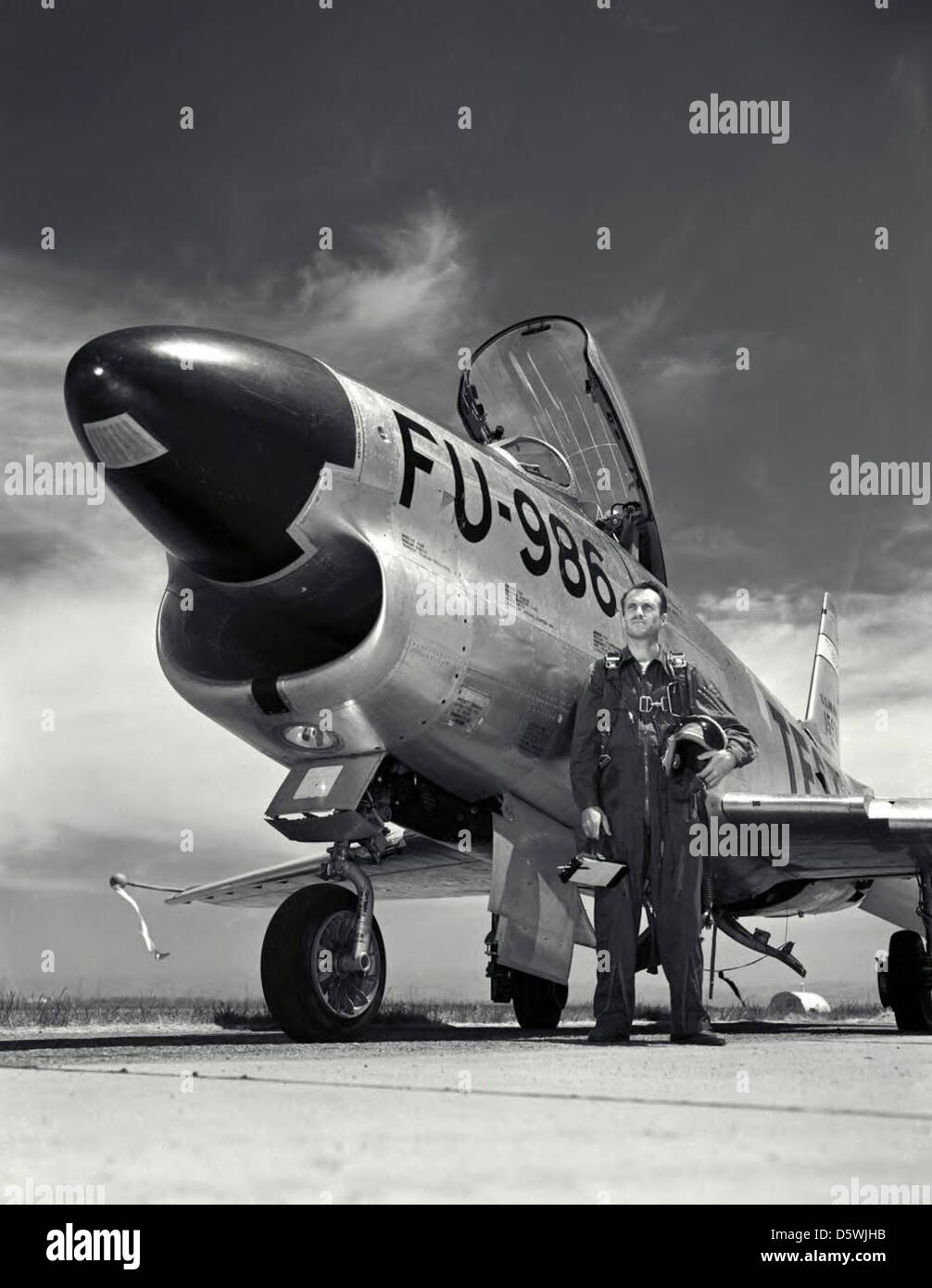 NACA test pilot George E. Cooper is seen standing alongside the North ...