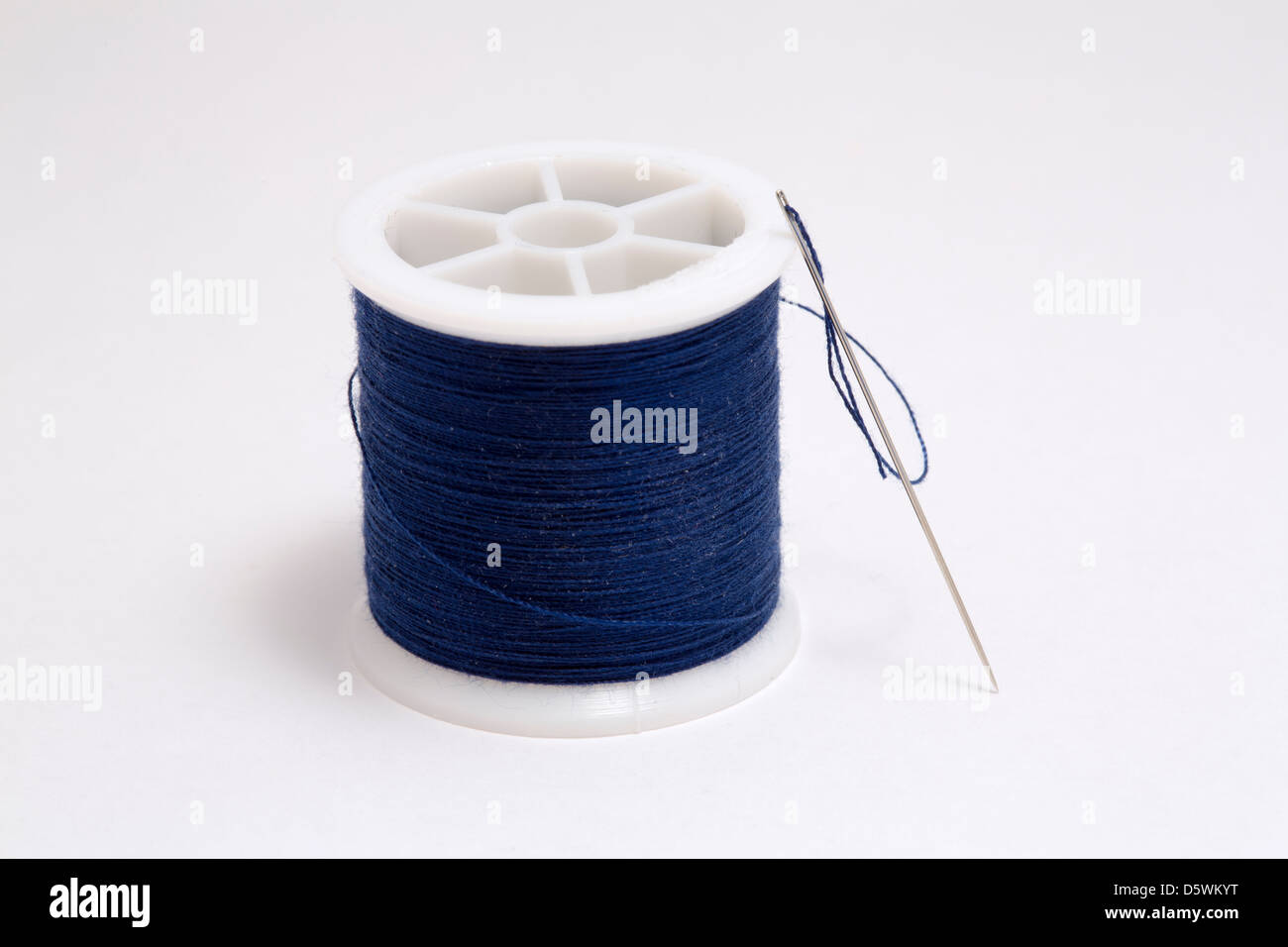 Needle and blue cotton thread Stock Photo - Alamy