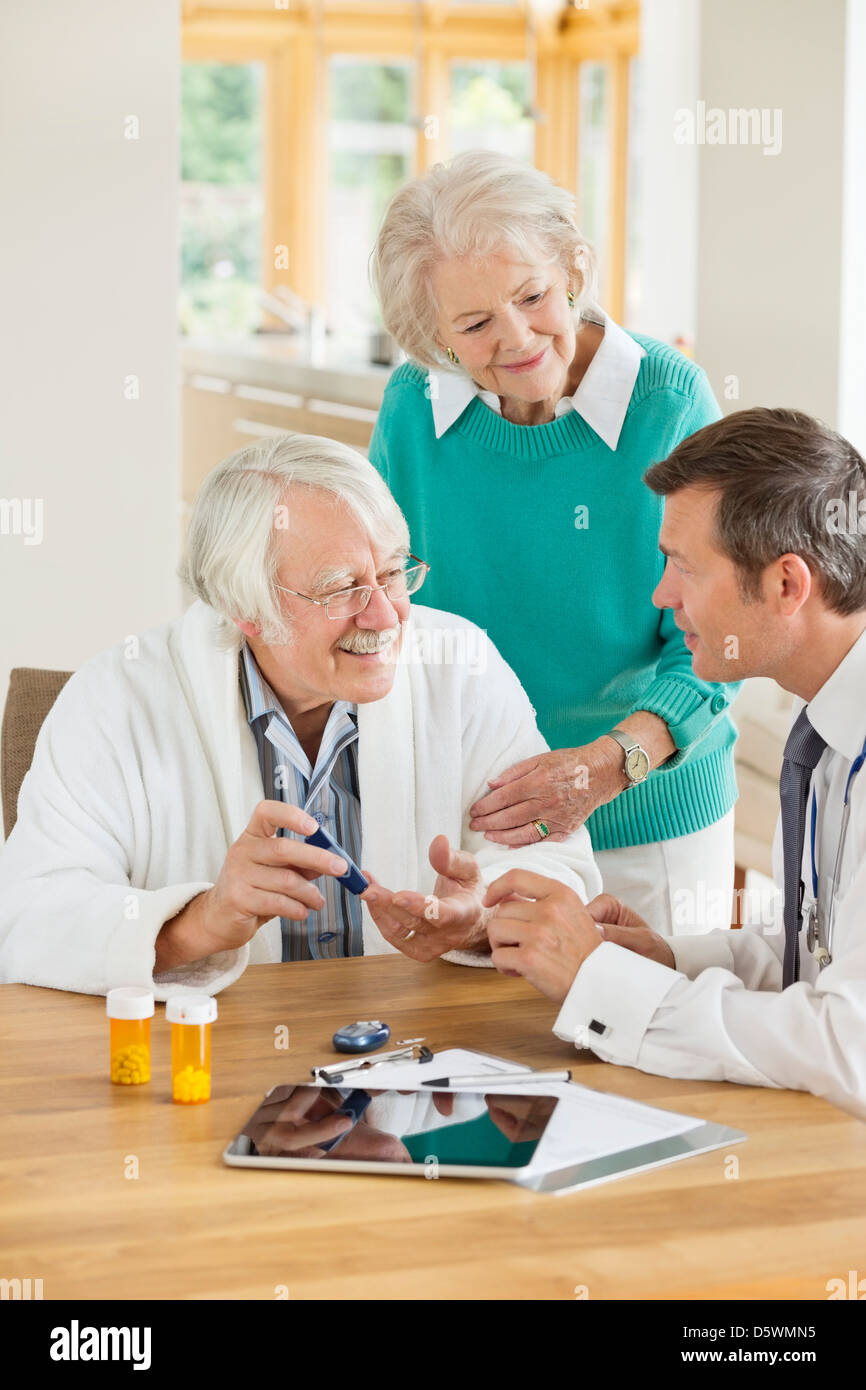 Doctor talking with older patient and wife Stock Photo - Alamy