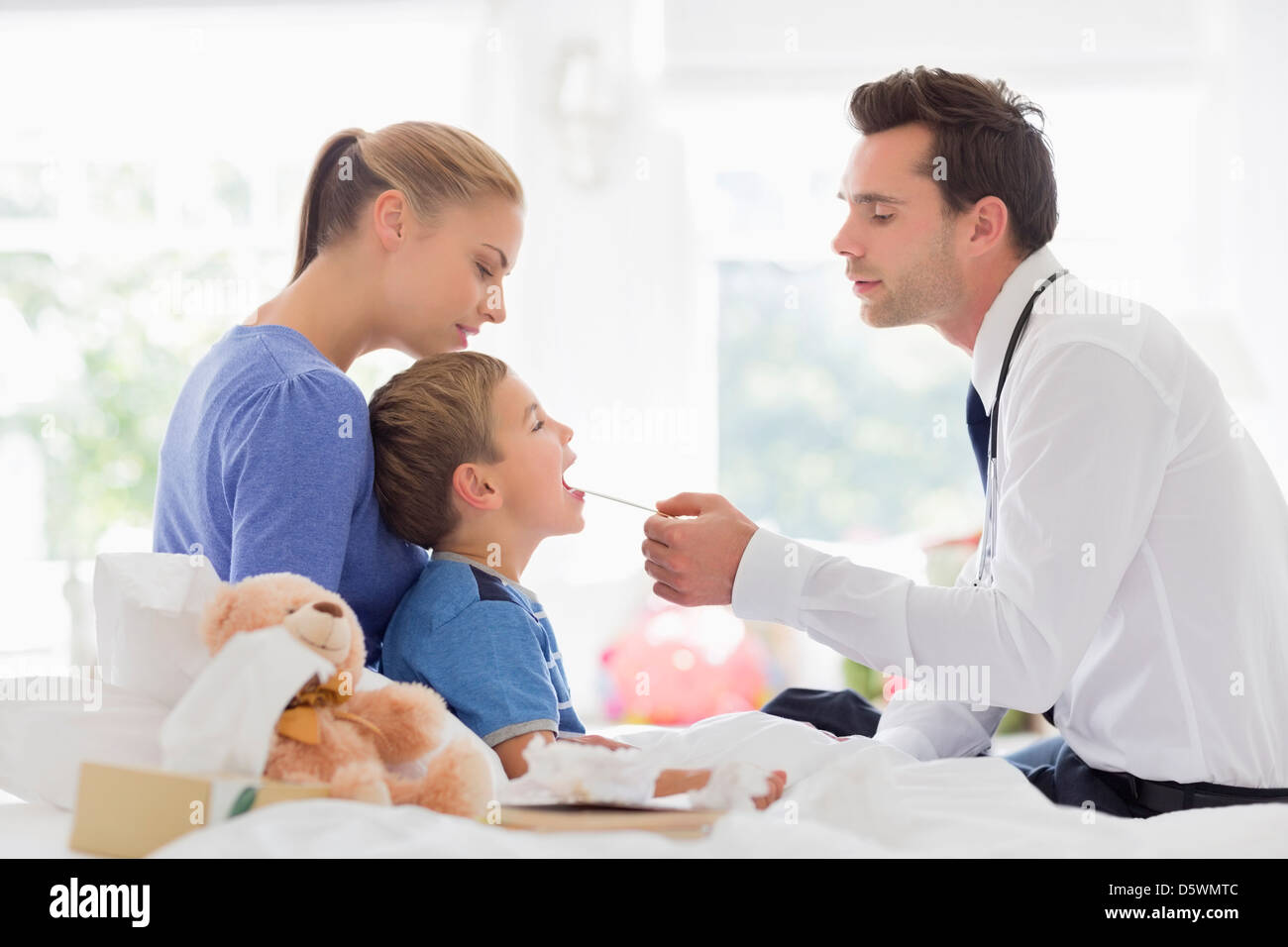 Doctor taking son's temperature Stock Photo - Alamy