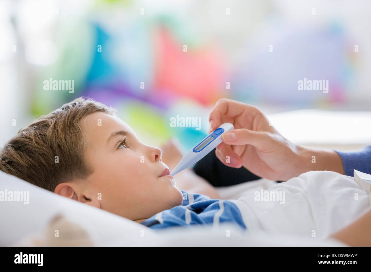 Mother taking son's temperature Stock Photo - Alamy