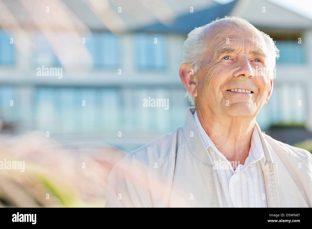 Smiling older man standing outdoors Stock Photo - Alamy