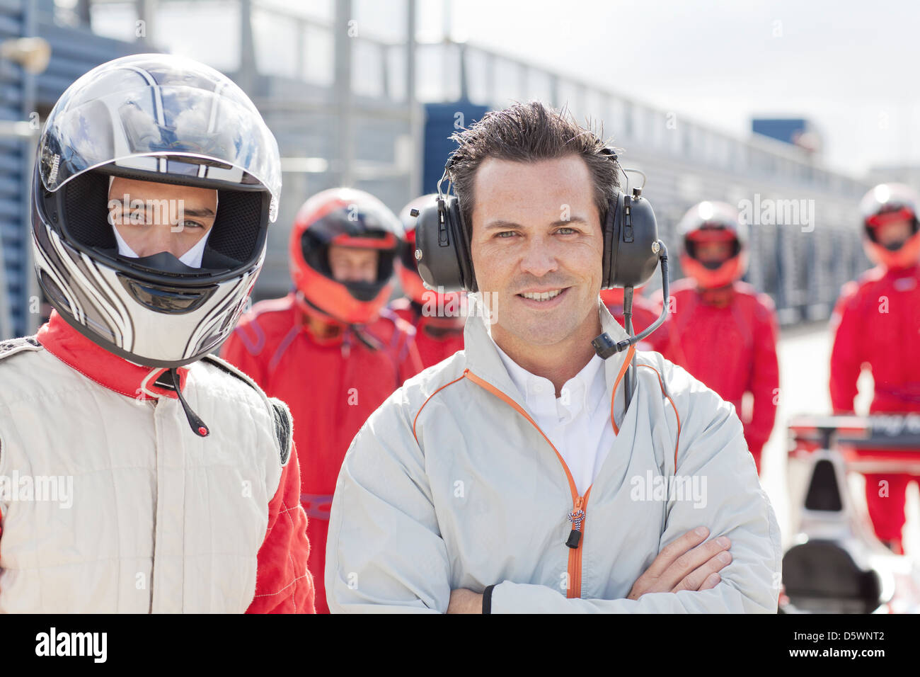 Racer and manager standing on track Stock Photo - Alamy