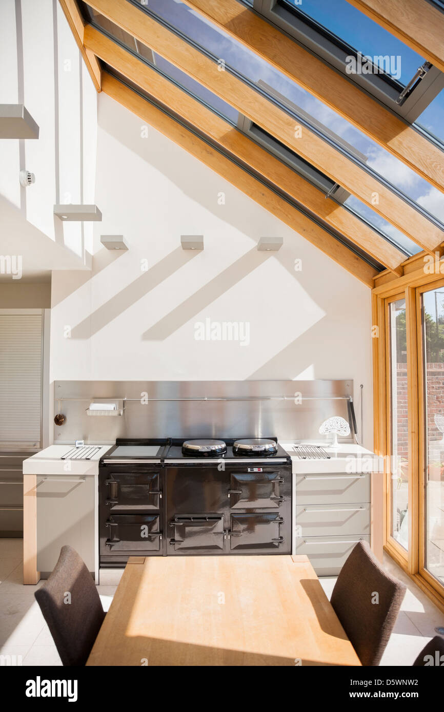Stove and table in modern kitchen Stock Photo - Alamy