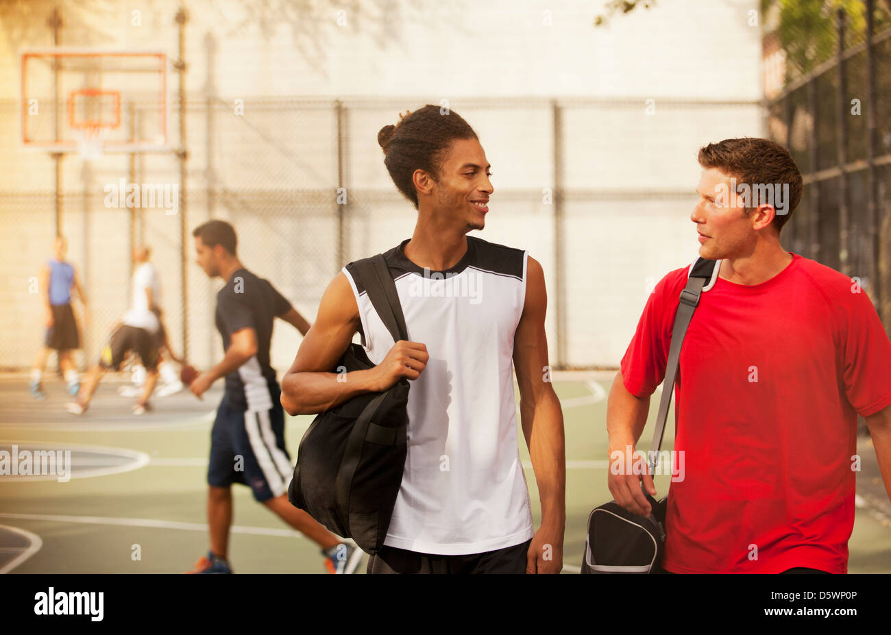 Men talking on basketball court Stock Photo - Alamy