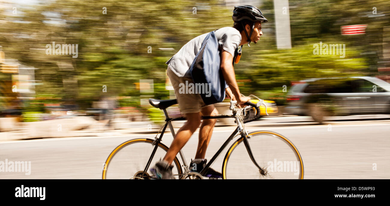 Man riding bicycle on city street Stock Photo - Alamy