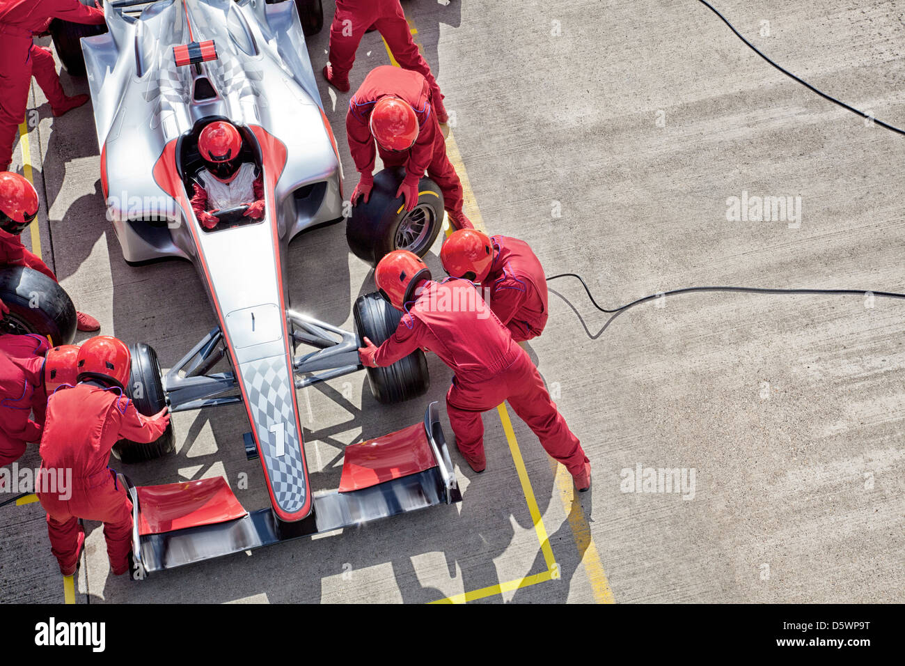 Racing team working at pit stop Stock Photo - Alamy