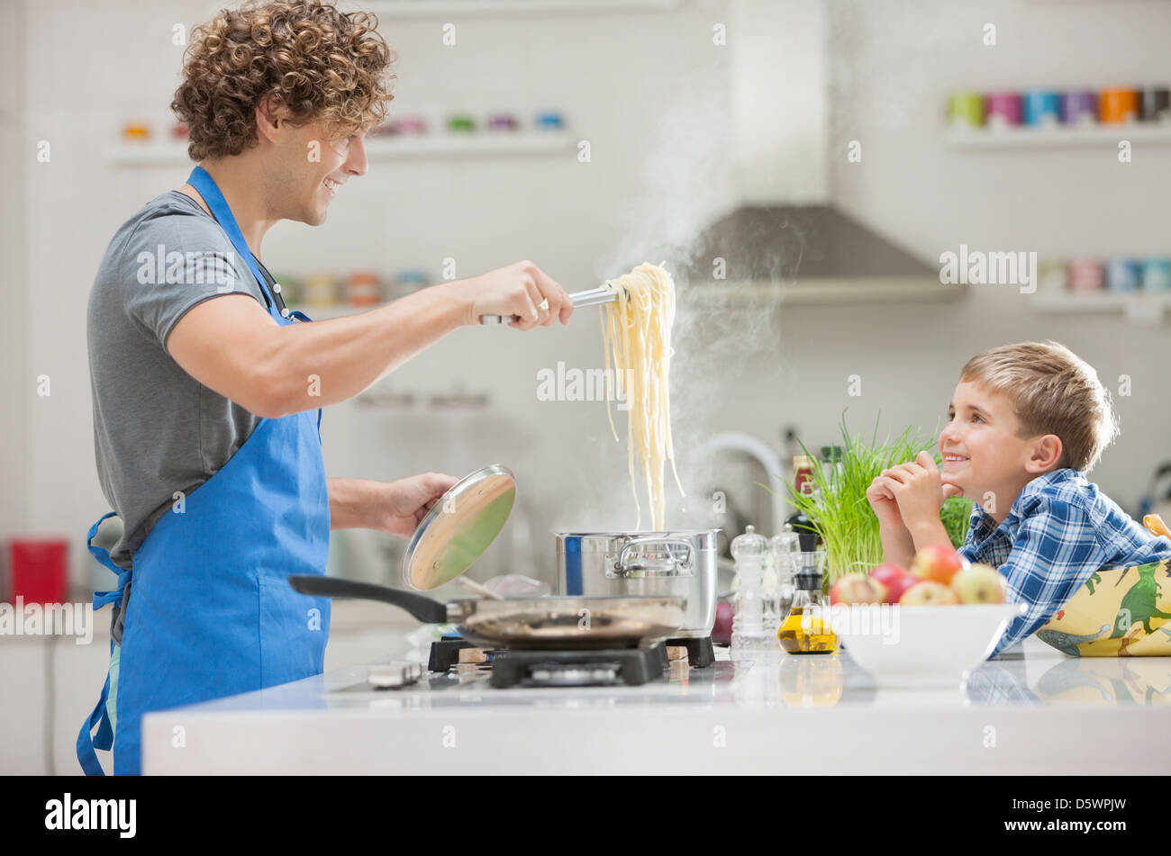 Father and son cooking in kitchen Stock Photo - Alamy