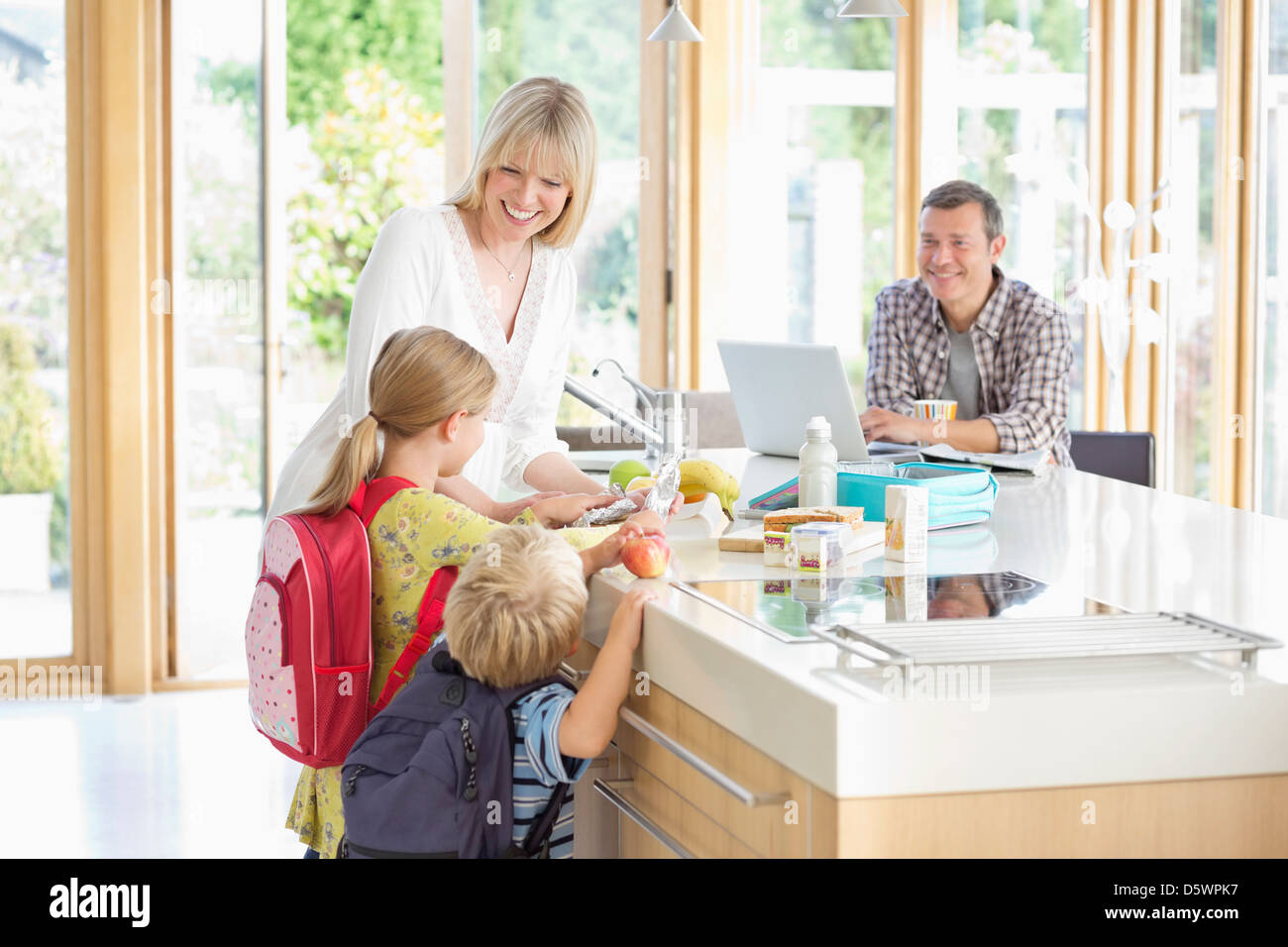 Family talking in kitchen Stock Photo - Alamy