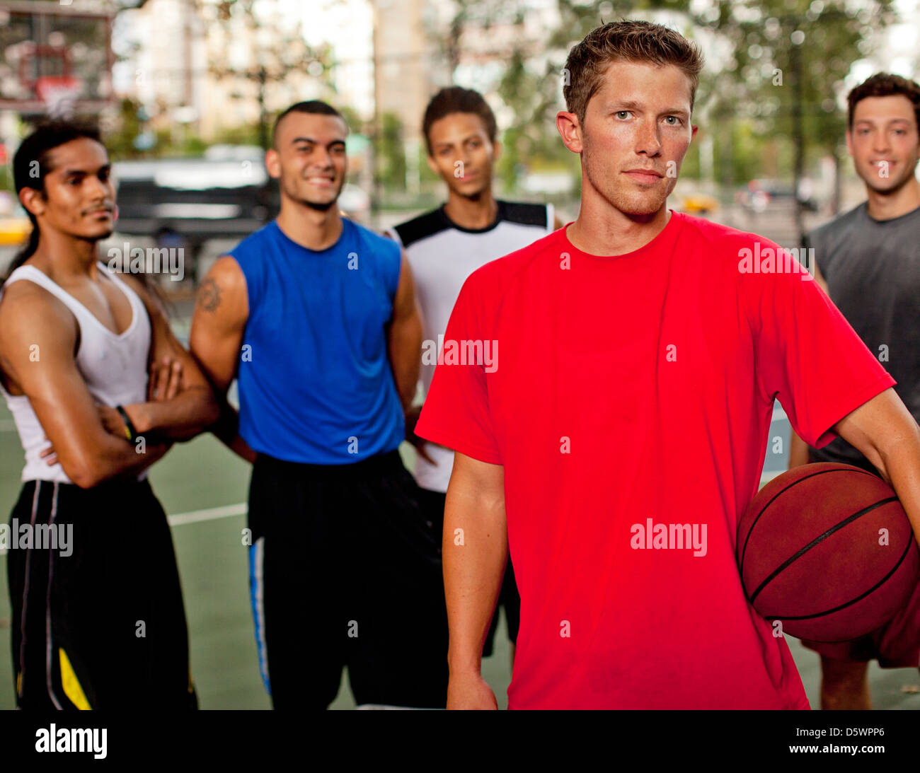 Men standing on basketball court Stock Photo - Alamy