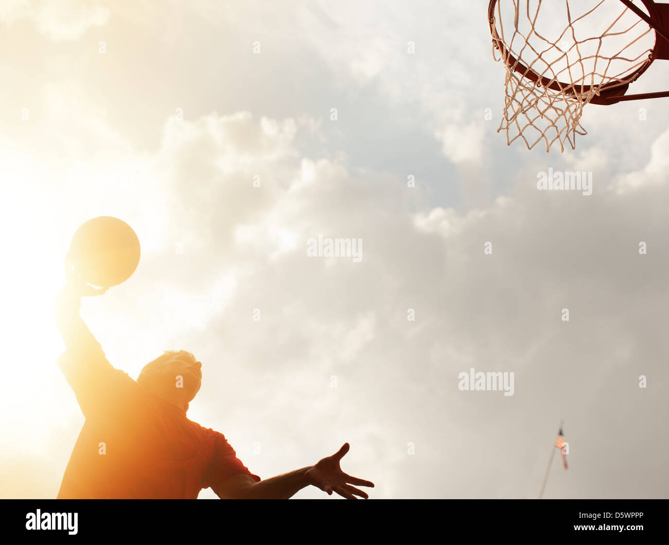 Man dunking basketball on court Stock Photo - Alamy