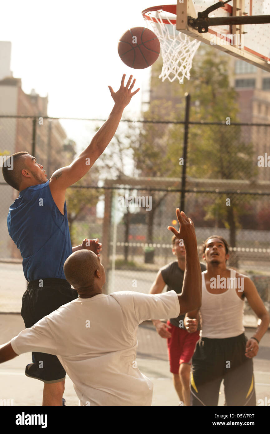 Men playing basketball on court Stock Photo - Alamy