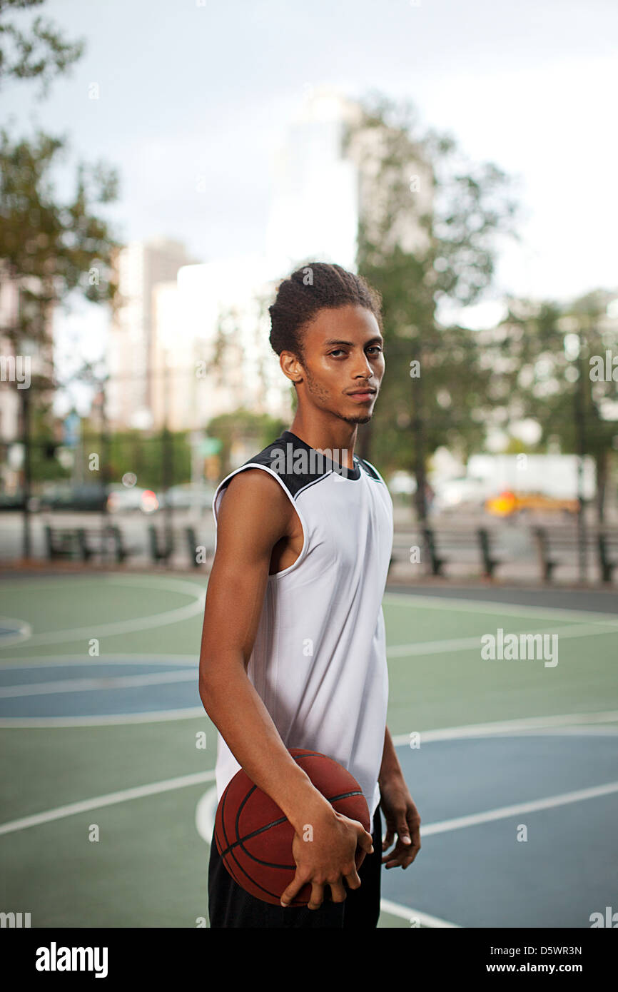 Man standing on basketball court Stock Photo - Alamy