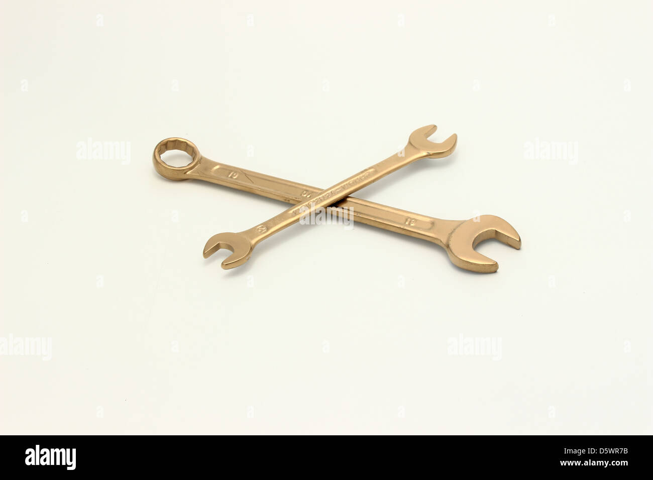 Golden wrench - The cost of labor Stock Photo - Alamy