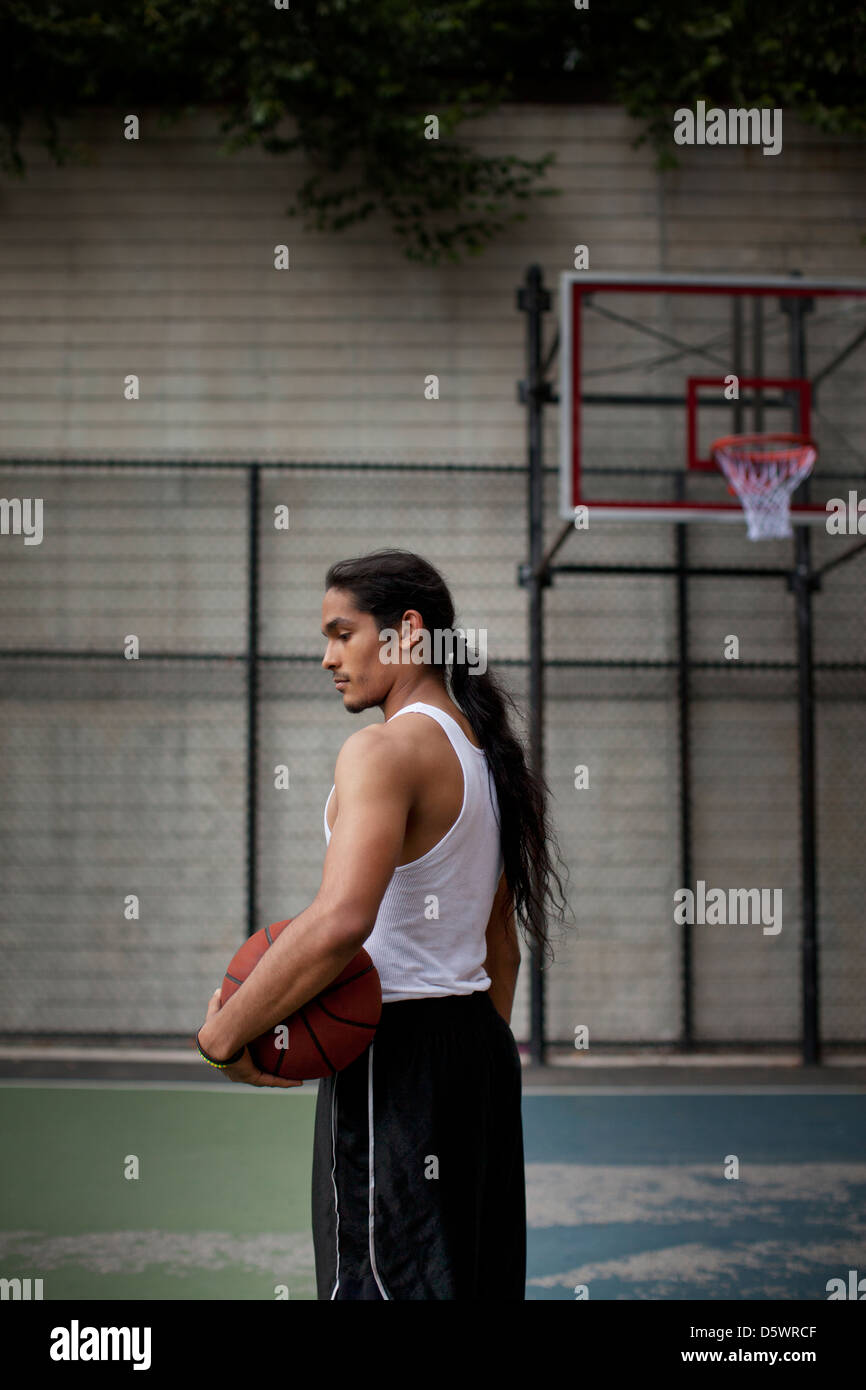 Man standing on basketball court Stock Photo - Alamy