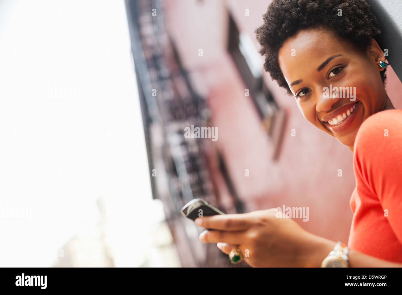 Woman using cell phone outdoors Stock Photo - Alamy