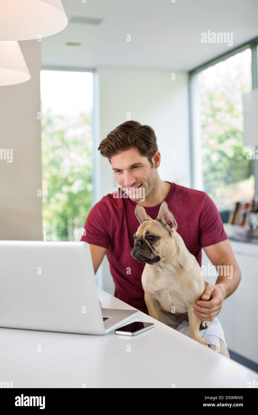 Man with dog on lap hi-res stock photography and images - Alamy