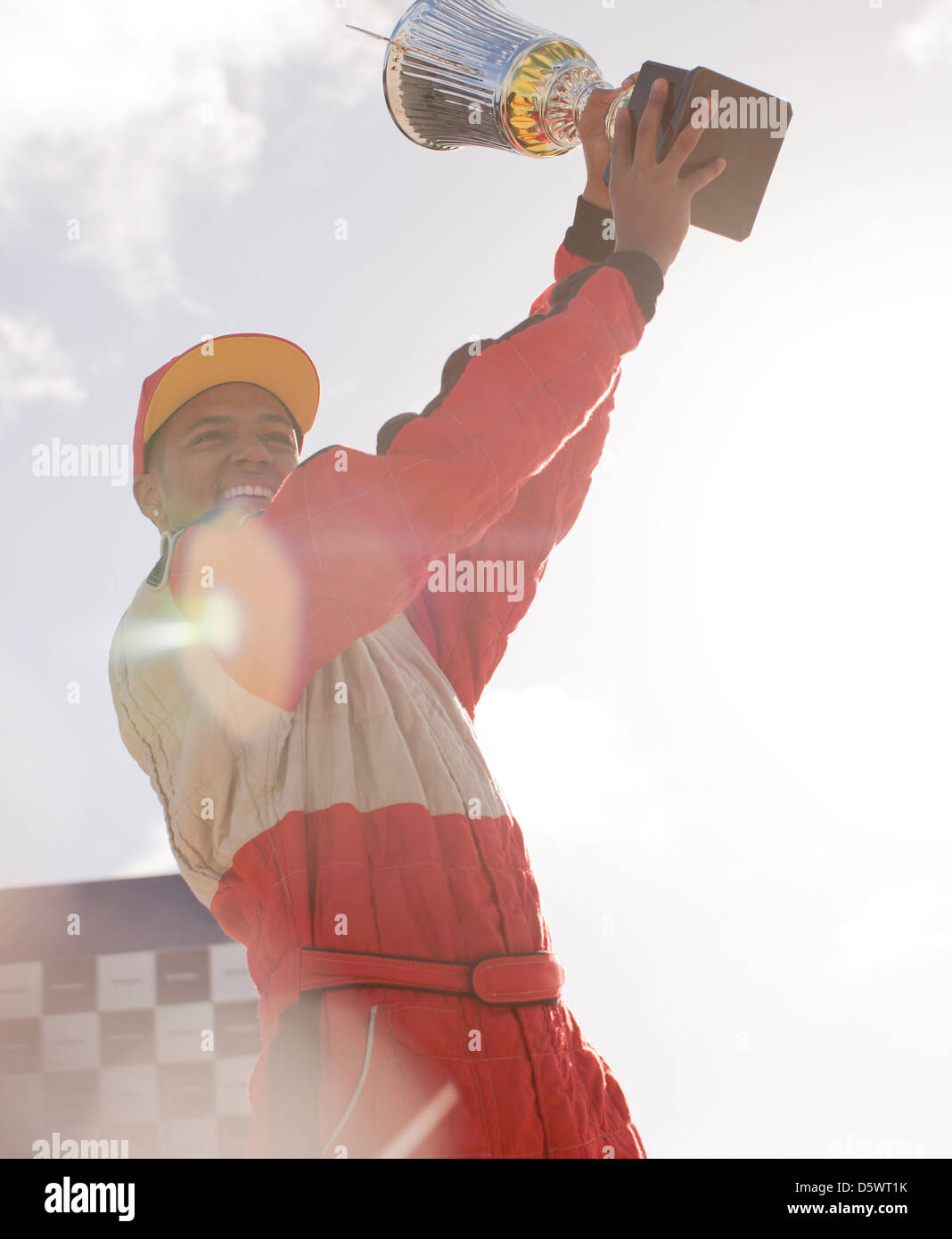 Racer holding trophy at award ceremony Stock Photo - Alamy