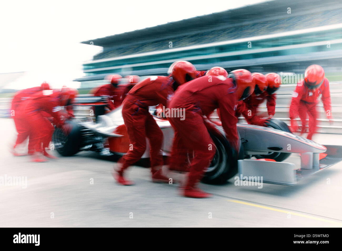 Racing team working at pit stop Stock Photo - Alamy