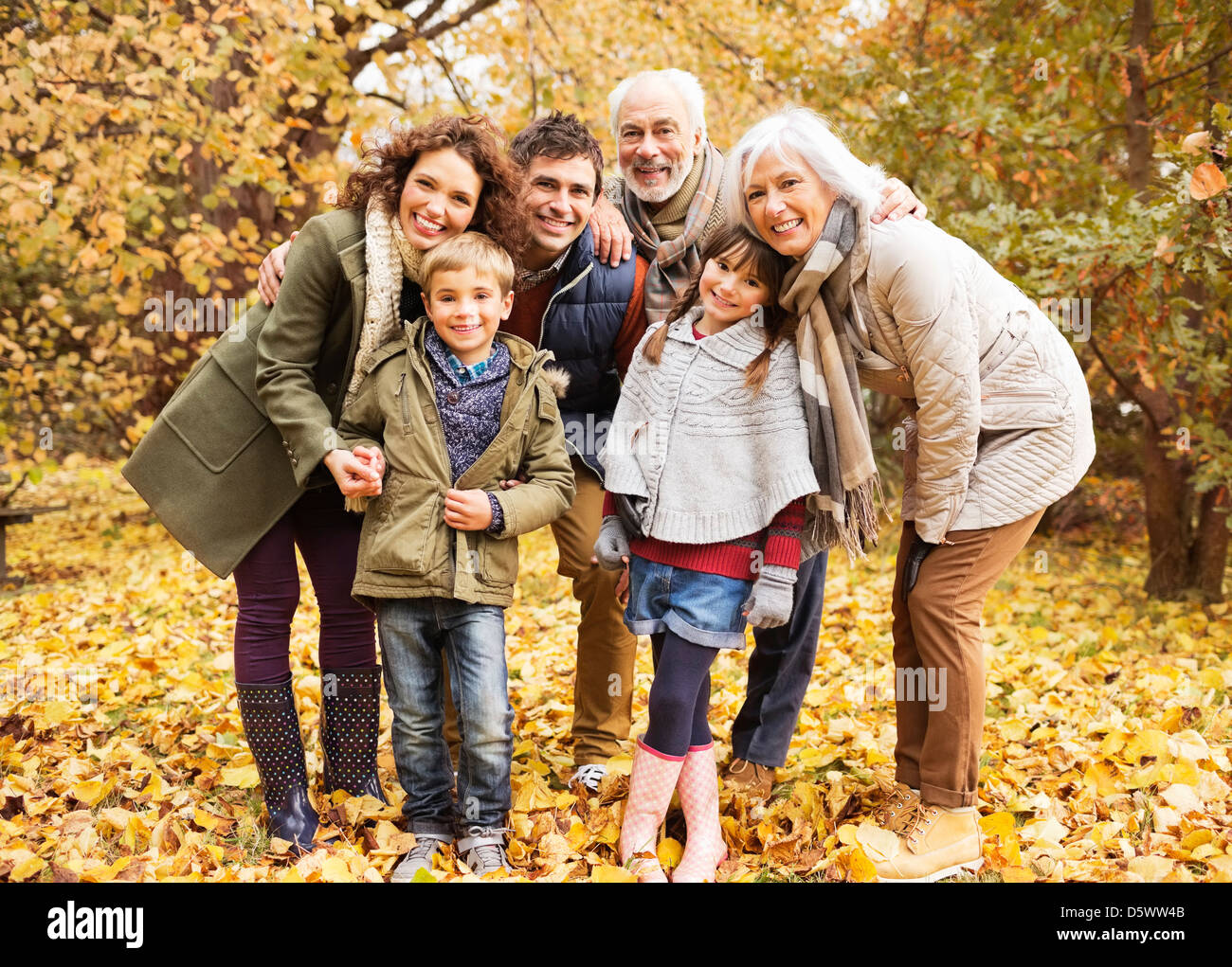 Family smiling together in park Stock Photo - Alamy