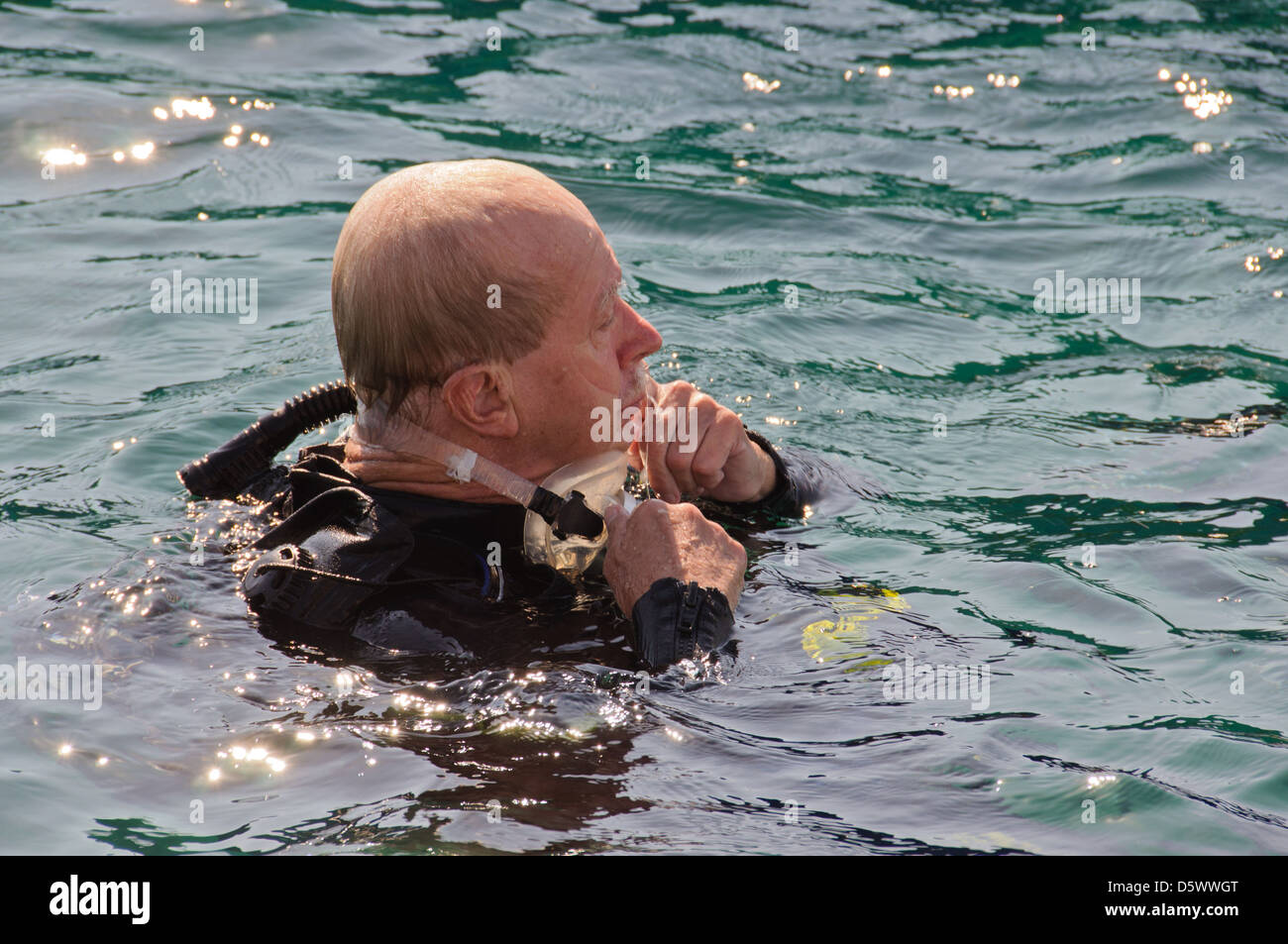 Caucasian senior citizen, retired man, SCUBA diver floats at the ...