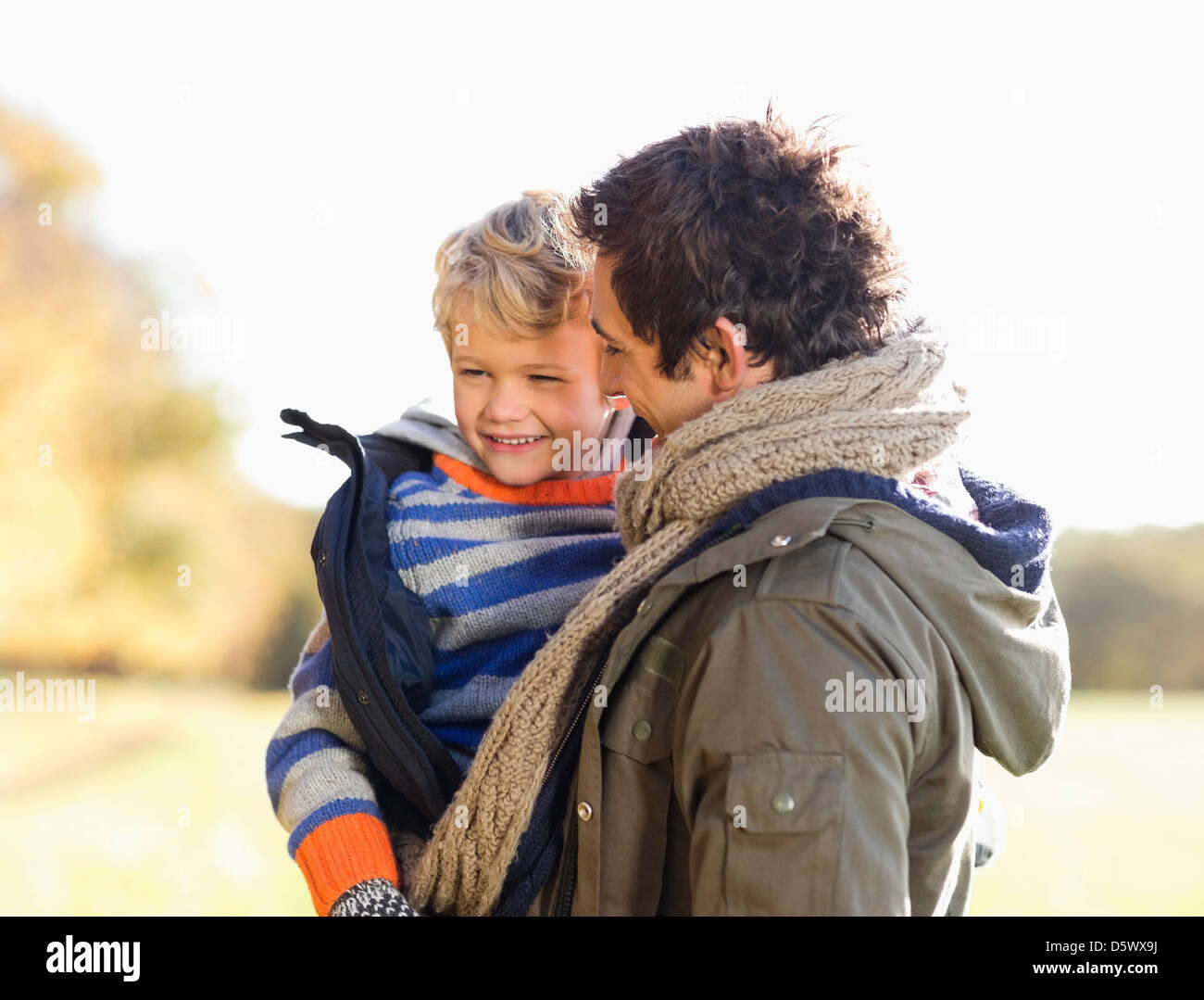 Father carrying son outdoors Stock Photo - Alamy