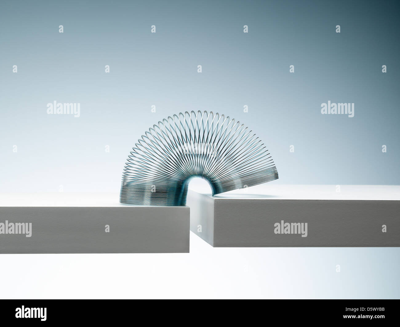 metal-slinky-spanning-space-between-blocks-stock-photo-alamy