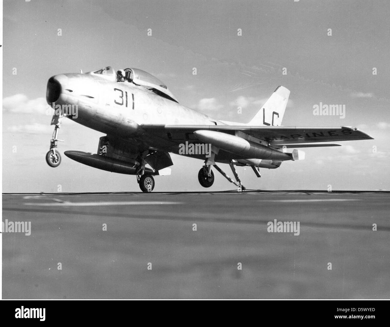 The North American FJ-2 Fury of VMF-122 catches the arresting cable on ...