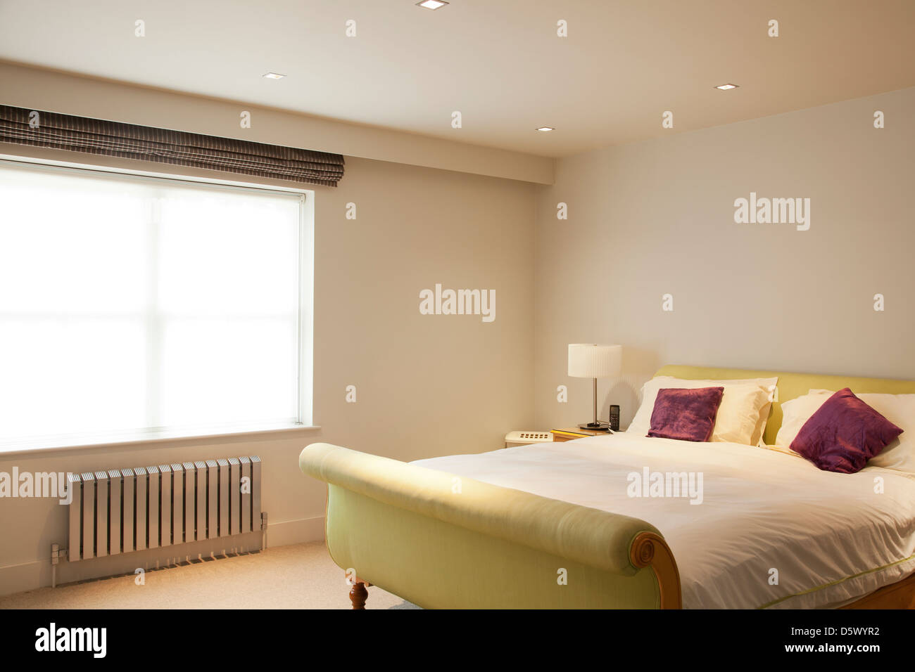 Bed and radiator in modern bedroom Stock Photo - Alamy