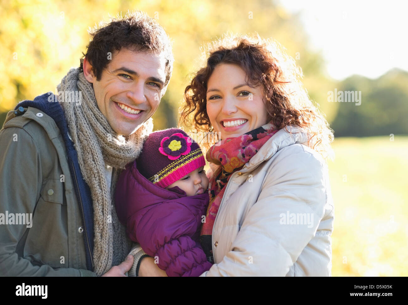Family smiling together in park Stock Photo - Alamy