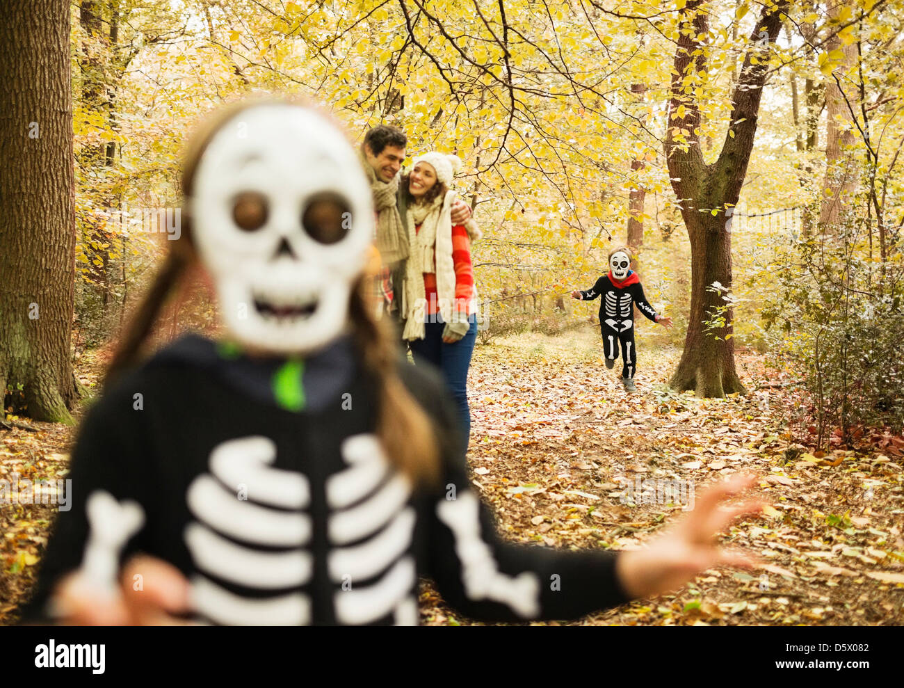Children in skeleton costumes playing in park Stock Photo - Alamy