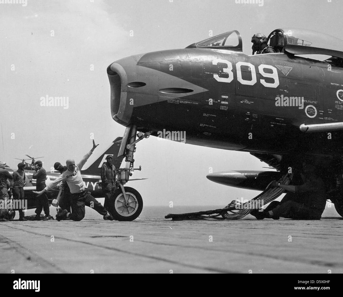 A North American FJ-3 Fury of VF-173 is positioned on the flight deck ...
